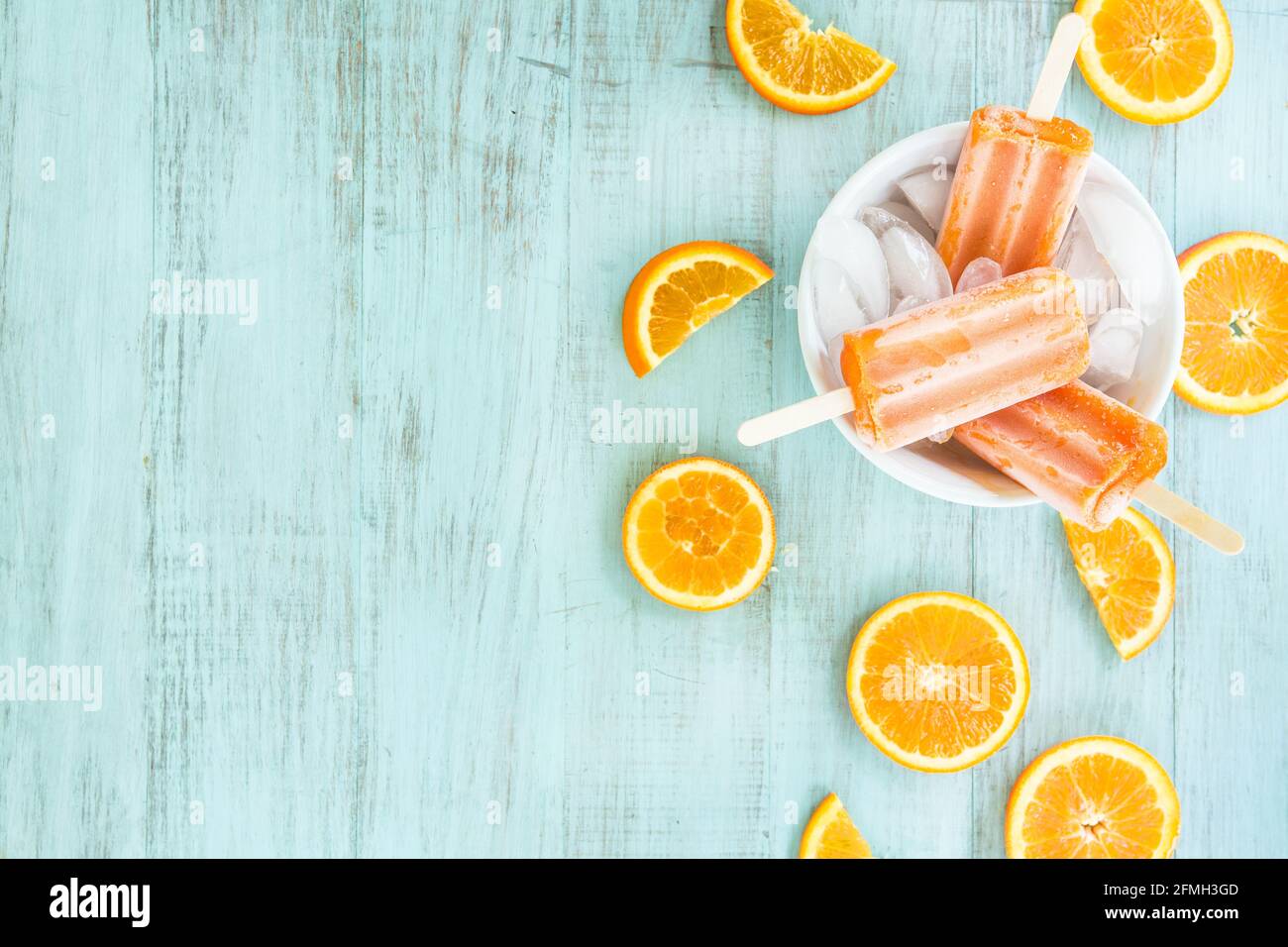 Tangerine popsicles in a bowl of ice with sliced oranges summer picnic ...