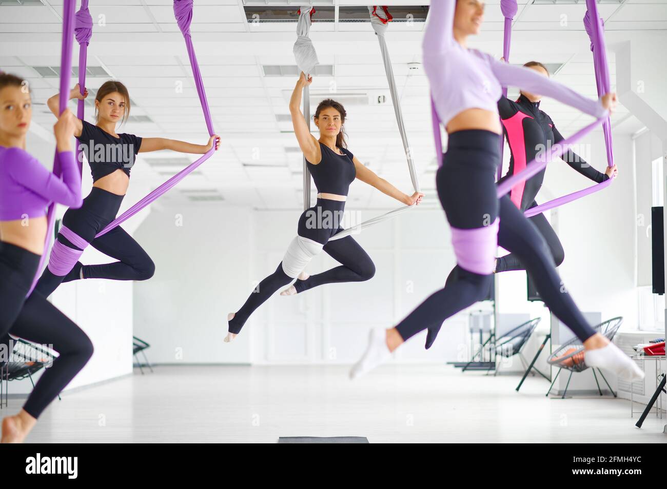 Fly yoga class, hanging on hammocks Stock Photo - Alamy