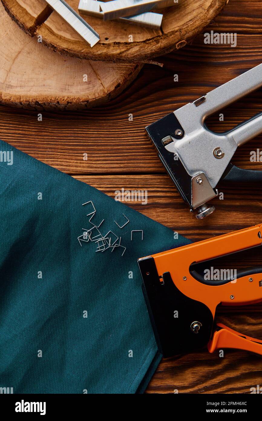 Stapler and staples on stump, wooden background Stock Photo - Alamy