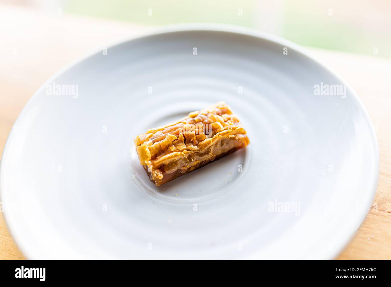 Macro closeup of Baklava pastry on white plate isolated with texture on ...