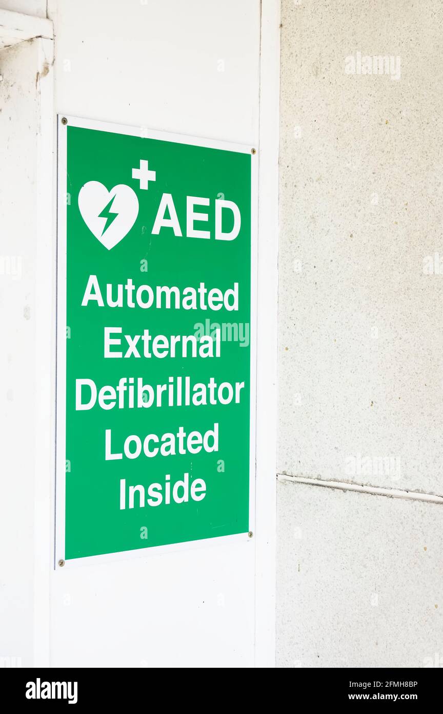 Defibrillator AED sign on wall in public space for emergency heart ...