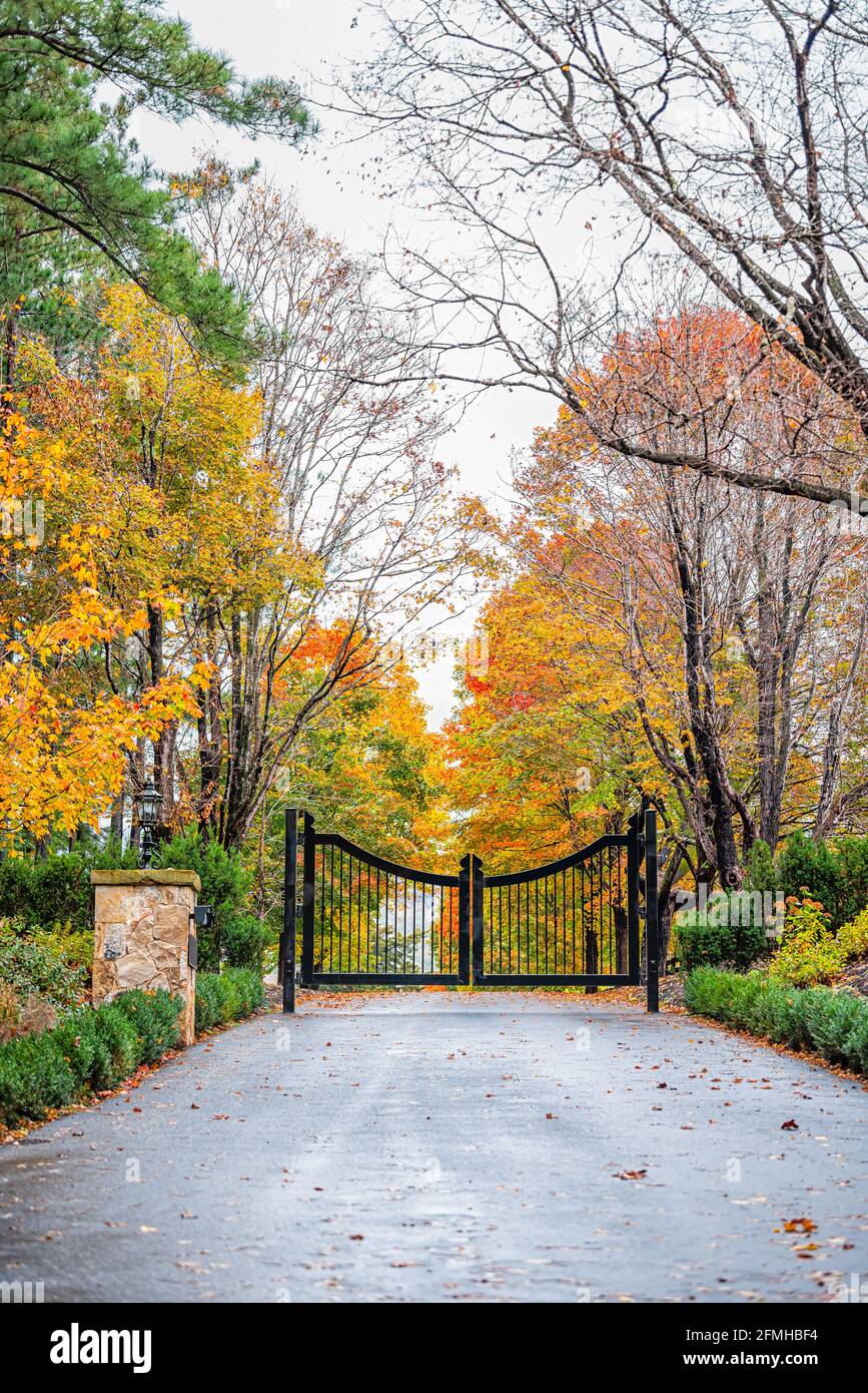 Countryside rural paved road to property estate with gates gateway ...