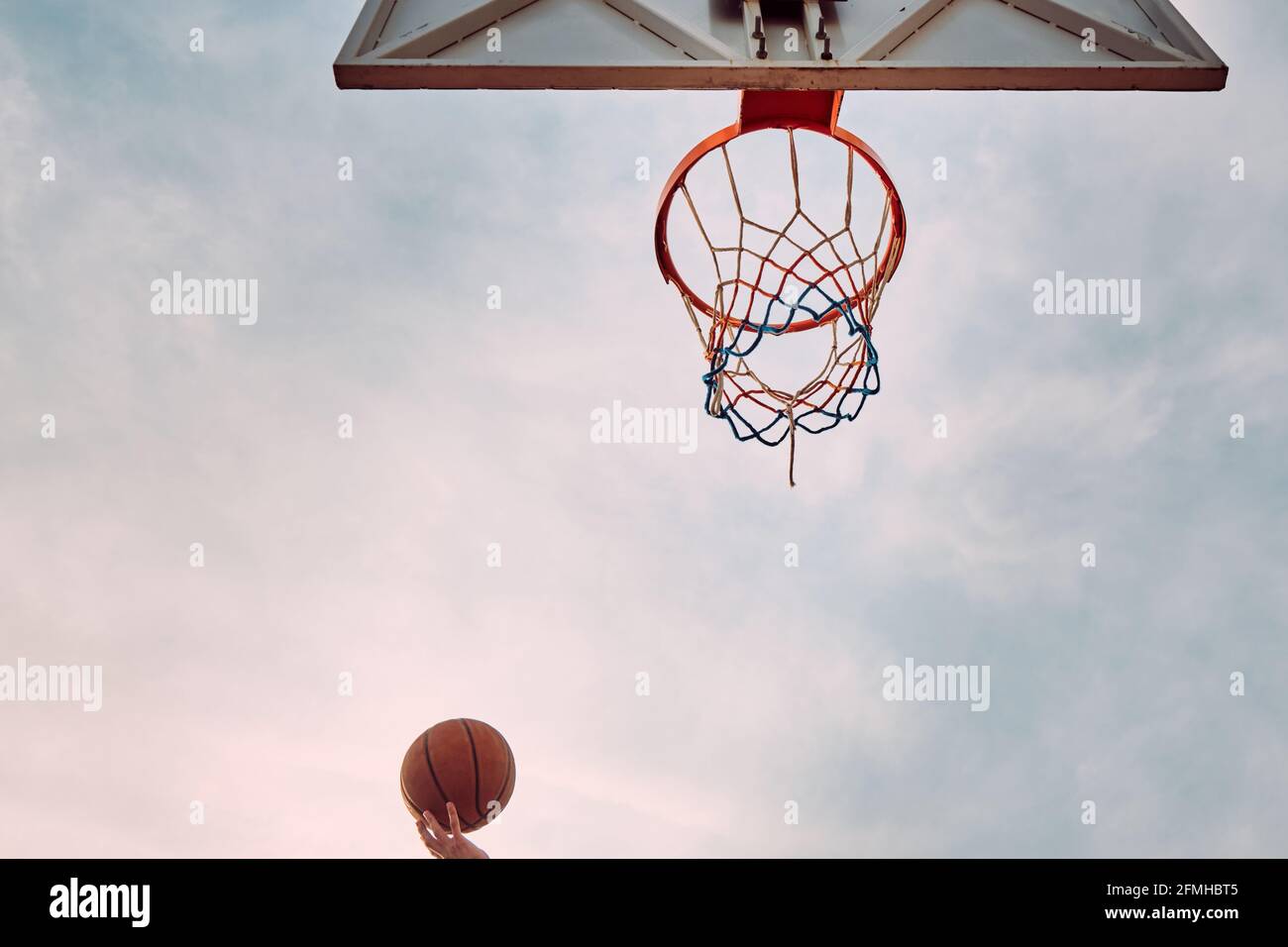 Hand throws basketball to the hoop Stock Photo - Alamy