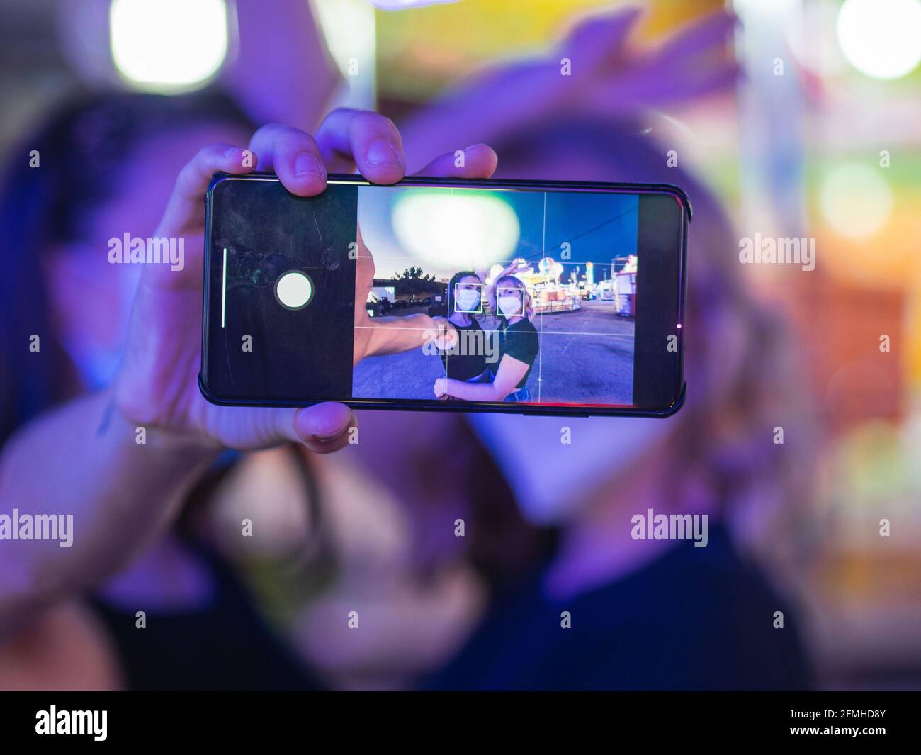 Female friends in masks doing a selfie in the evening Stock Photo - Alamy