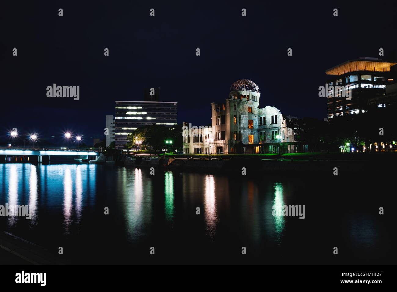 The Atomic Bomb Dome, memorial for the second world war, along the river with light reflections ...