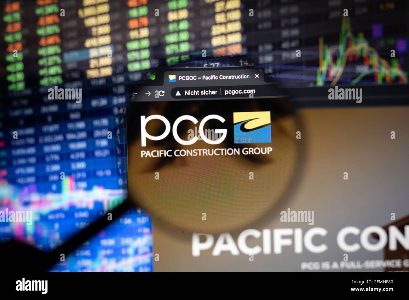 Pacific Construction Group company logo on a website with blurry stock ...