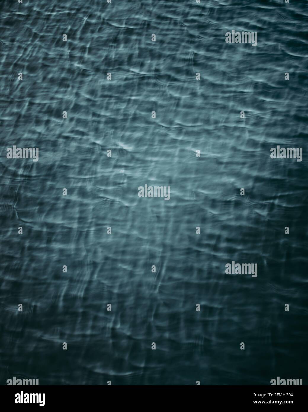 A vertical background of blue wavy ocean water Stock Photo - Alamy