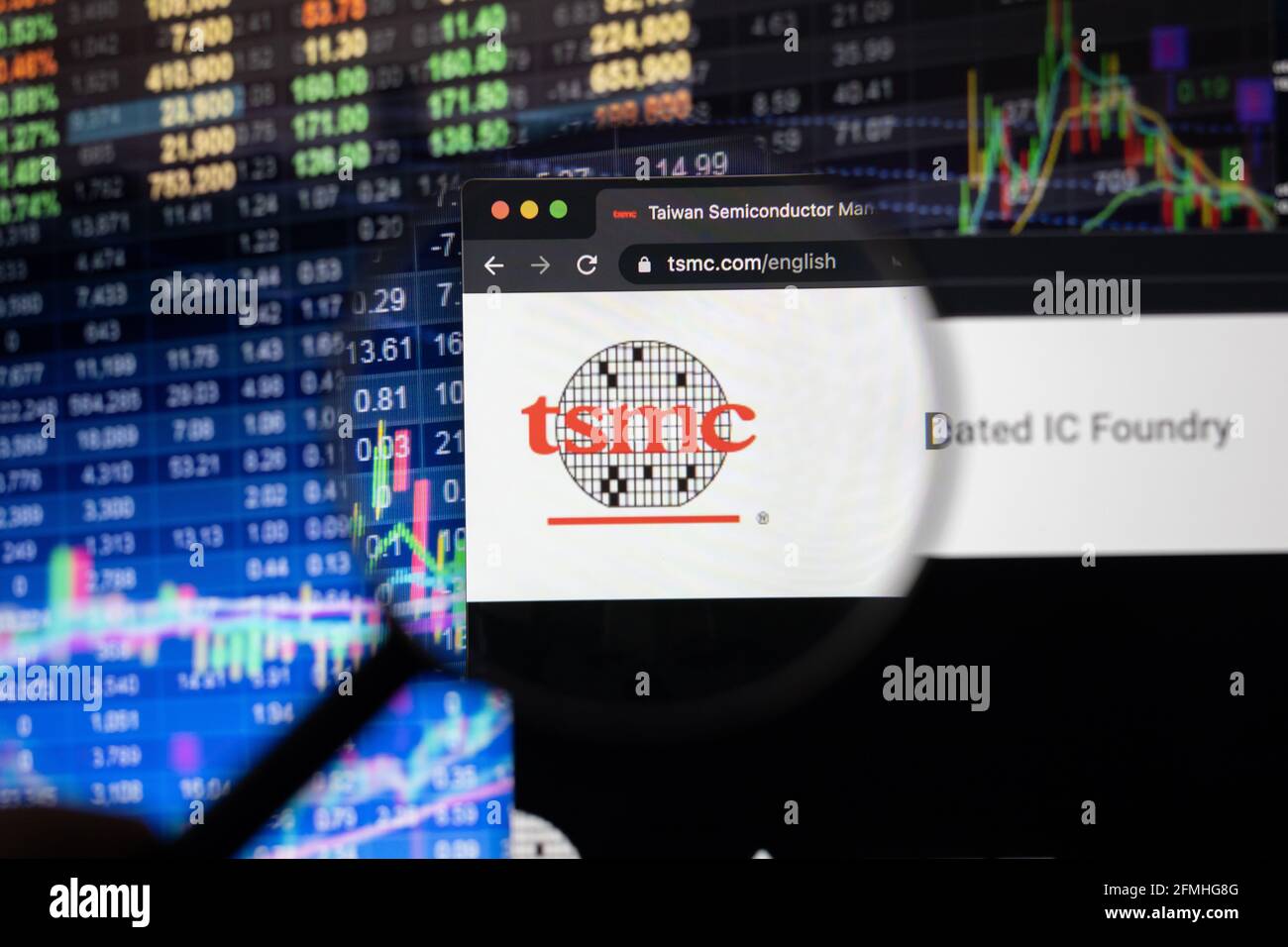 TSMC company logo on a website with blurry stock market developments in the background, seen on ...