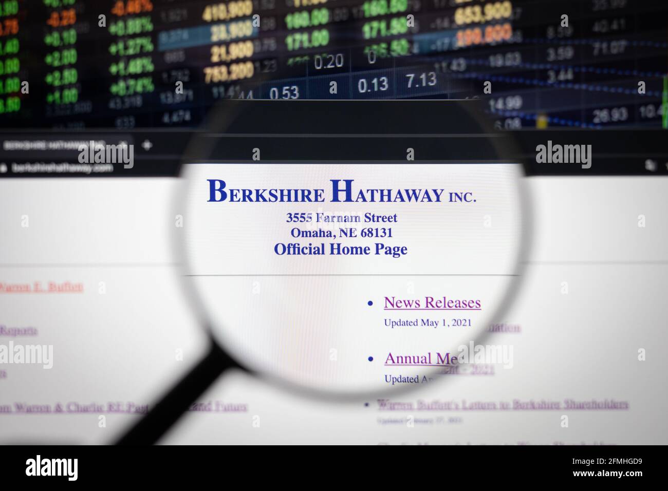 Berkshire Hathaway Inc. company logo on a website with blurry stock market developments in the ...