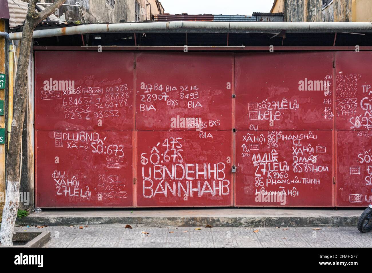 Vietnamese words chalked up on red wall in old town, Hoi An, Vietnam ...