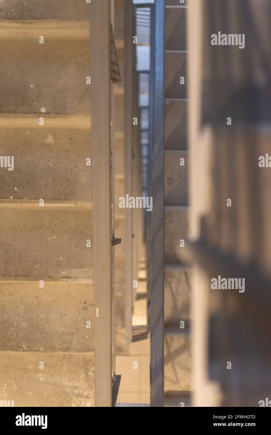 A flight of stairs in a high-rise building. Stairs going deep down ...