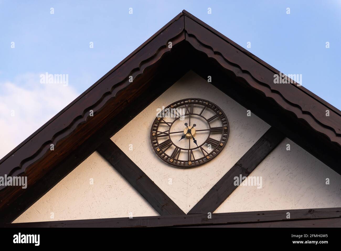 Large clock on a private house. Street clock in the bay window with ...