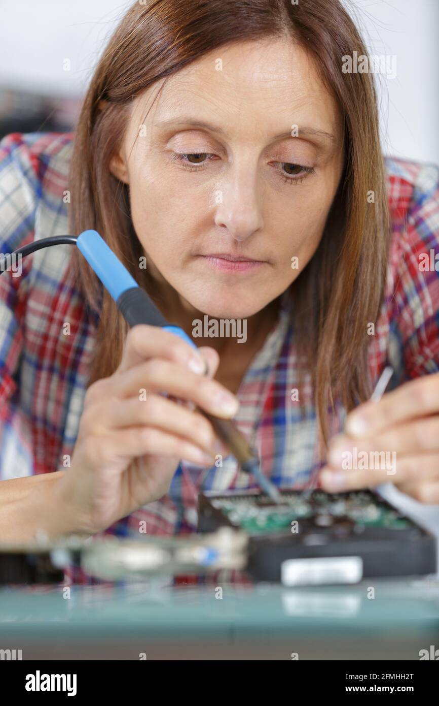 Woman soldering elements circuit hi-res stock photography and images ...
