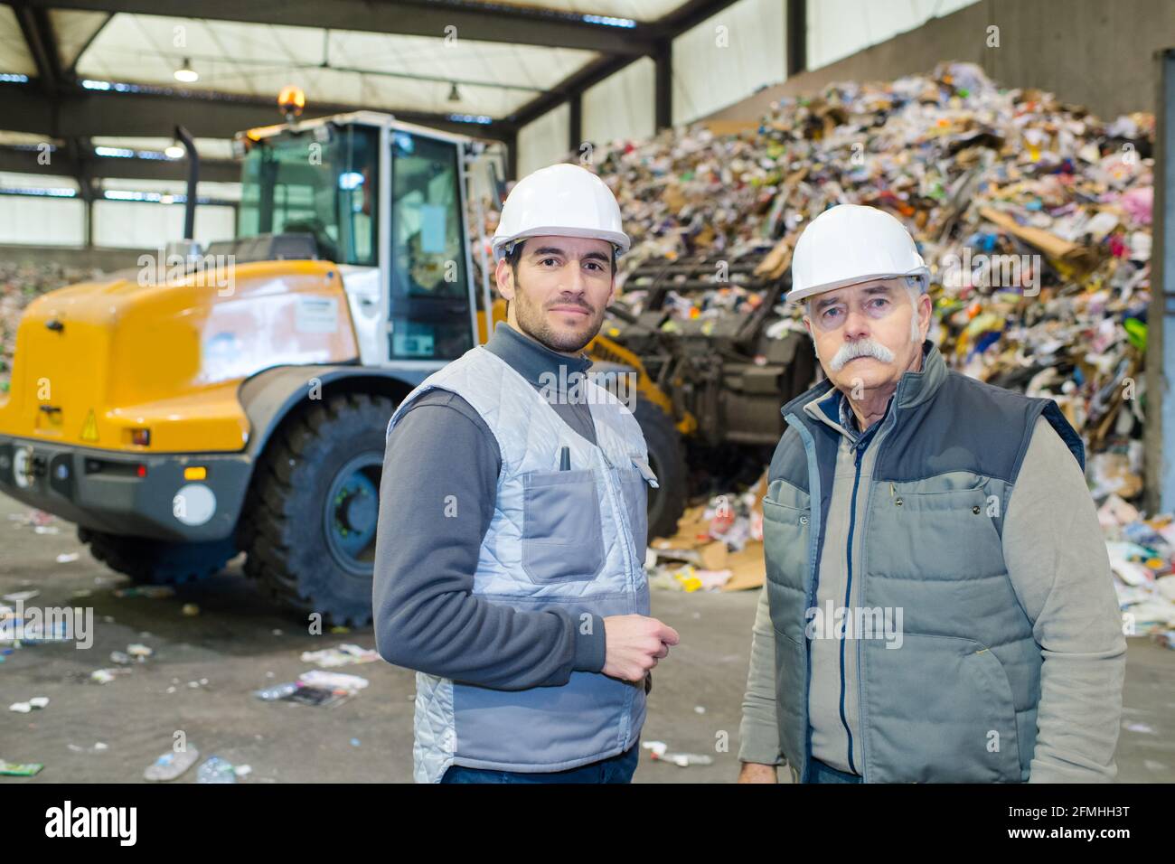 male workers with clipboard checking waste recycling Stock Photo - Alamy