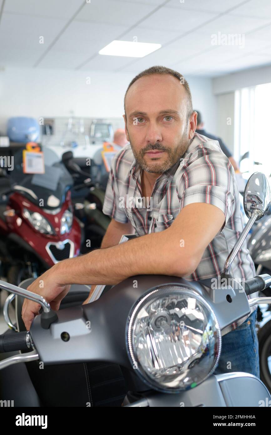 a man with motorcycle workshop Stock Photo - Alamy