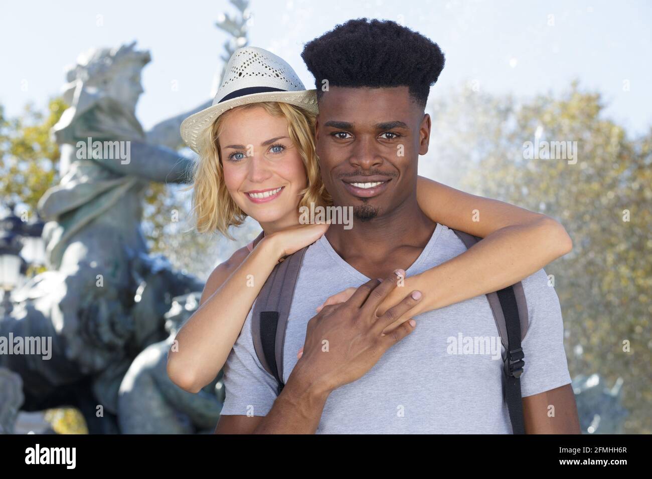 mixed couple in love hugging outdoors Stock Photo - Alamy