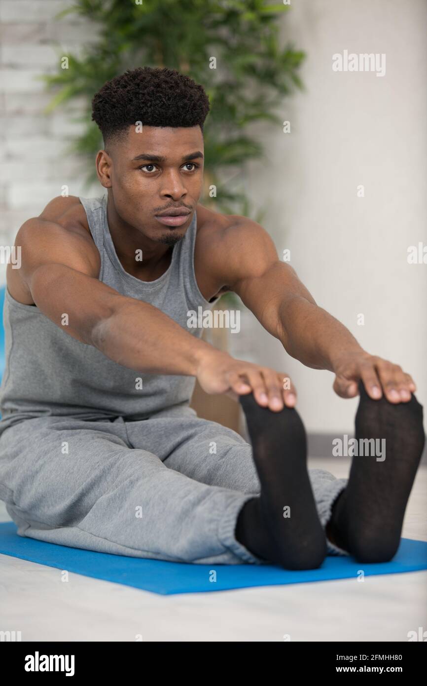 handsome young man doing hamstring stretch exercise Stock Photo - Alamy