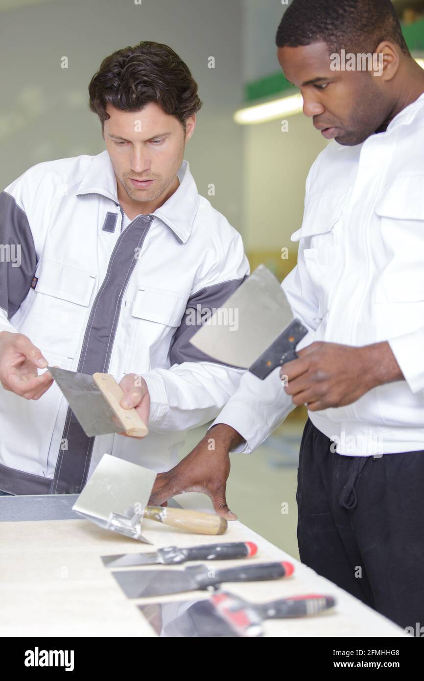 two builders making finish in the apartment Stock Photo - Alamy