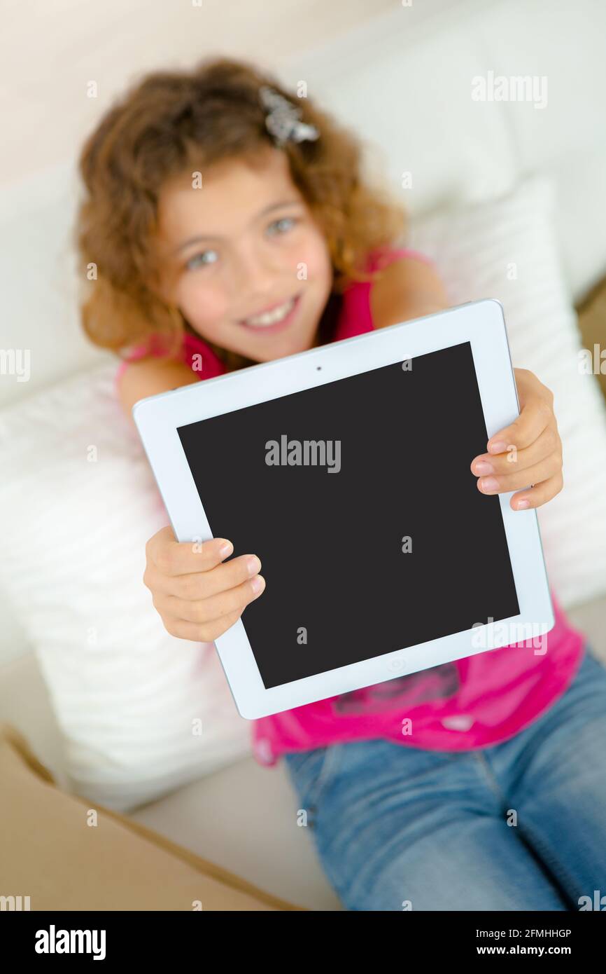 Young girl showing screen of her tablet Stock Photo - Alamy