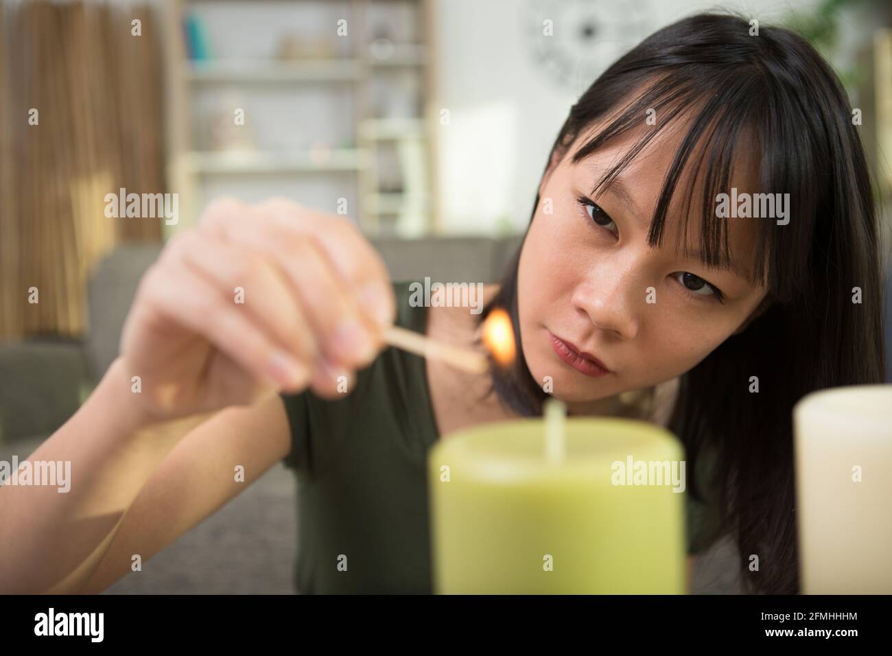 woman lighting up the candle on the candle Stock Photo - Alamy