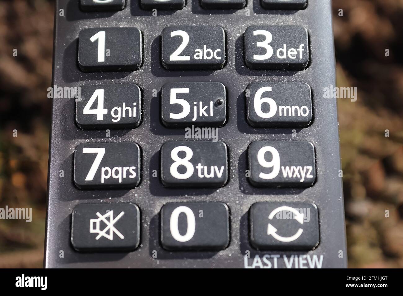 A closeup of the numbers on the black dirty old TV remote control Stock ...