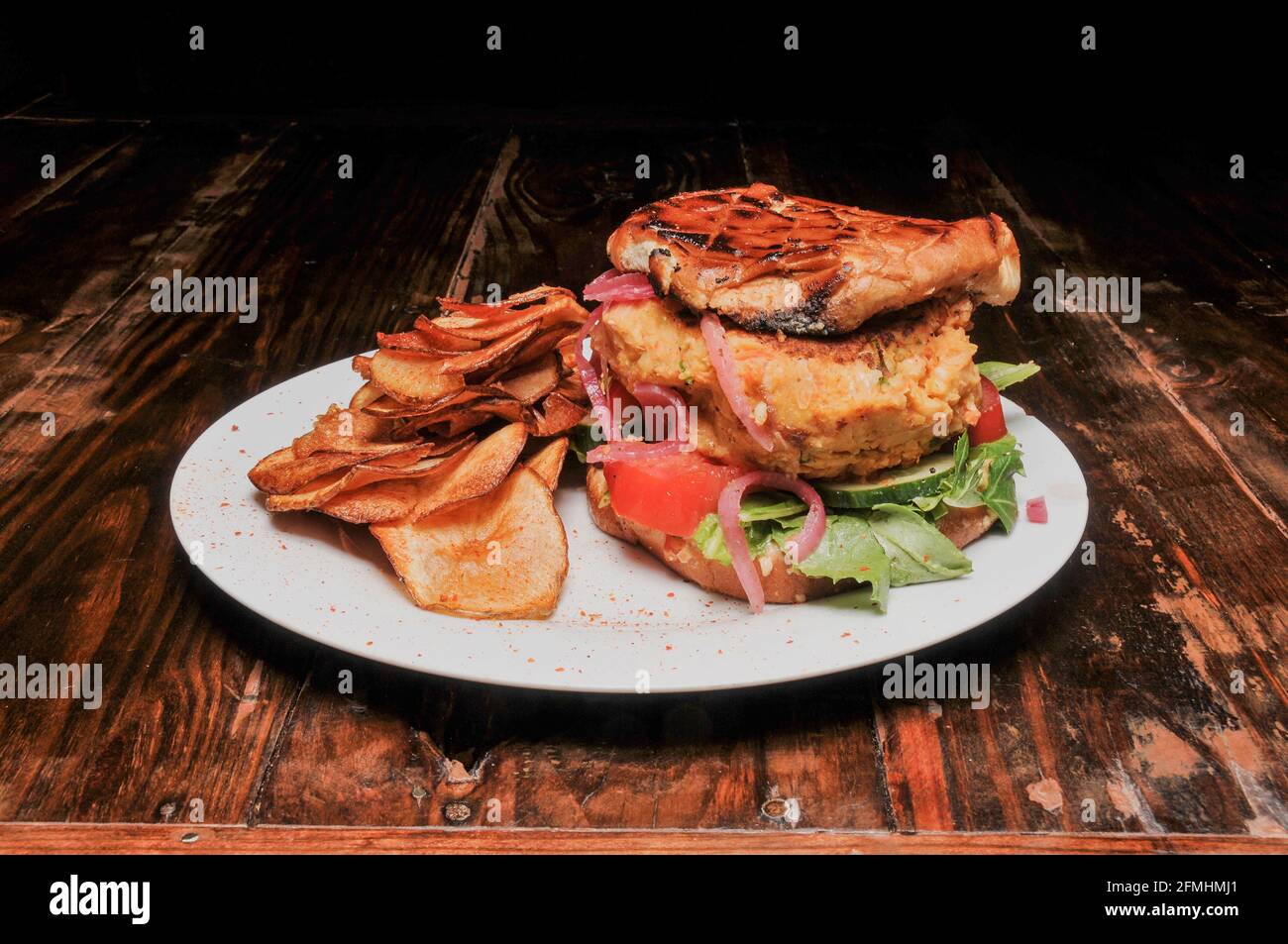 Delicious beyond burger with all the fixings on a bun Stock Photo - Alamy