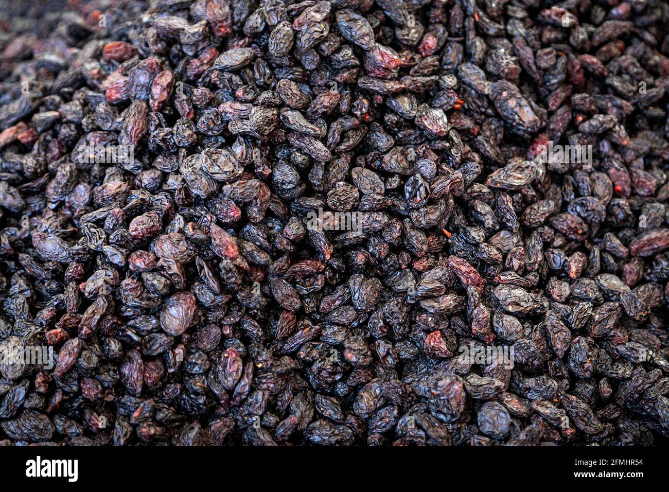 Close-up of purple raisins on a showcase in a supermarket, top view ...