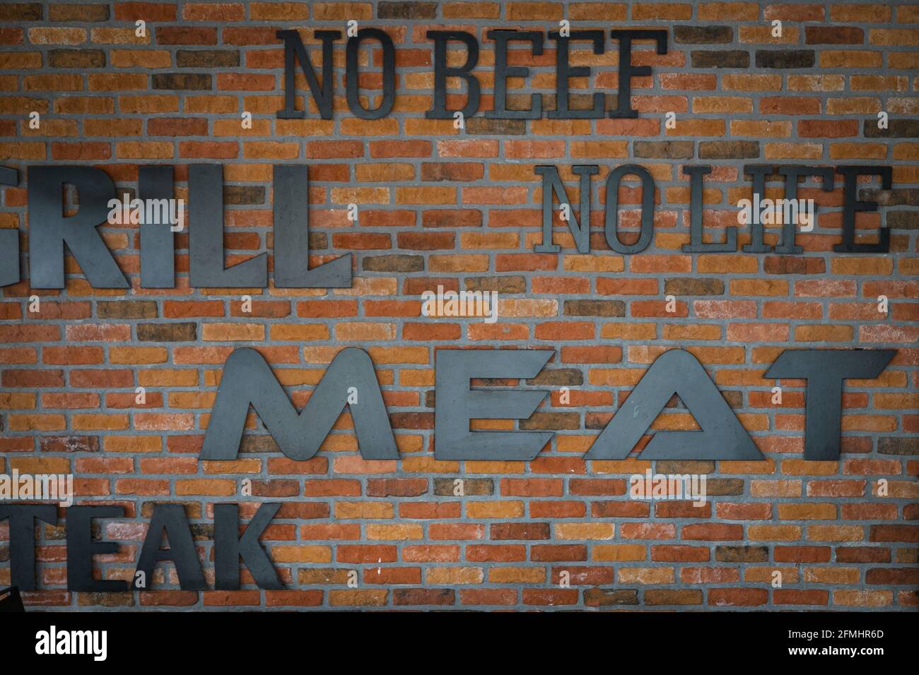 Brick wall with the words "No beef, no life, grill, meat, steak". The ...