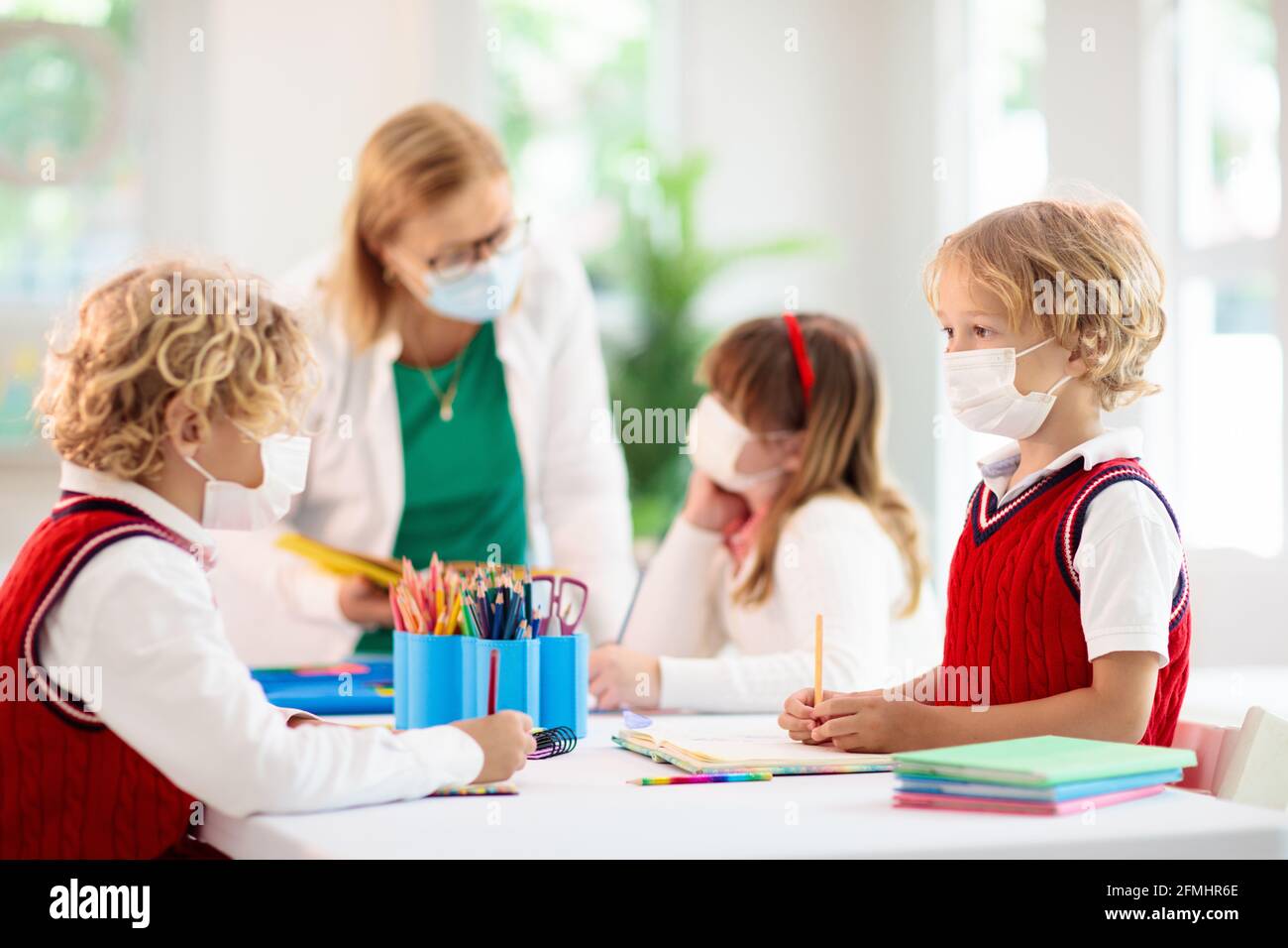 Kids in face mask in school class. Child back to school after ...