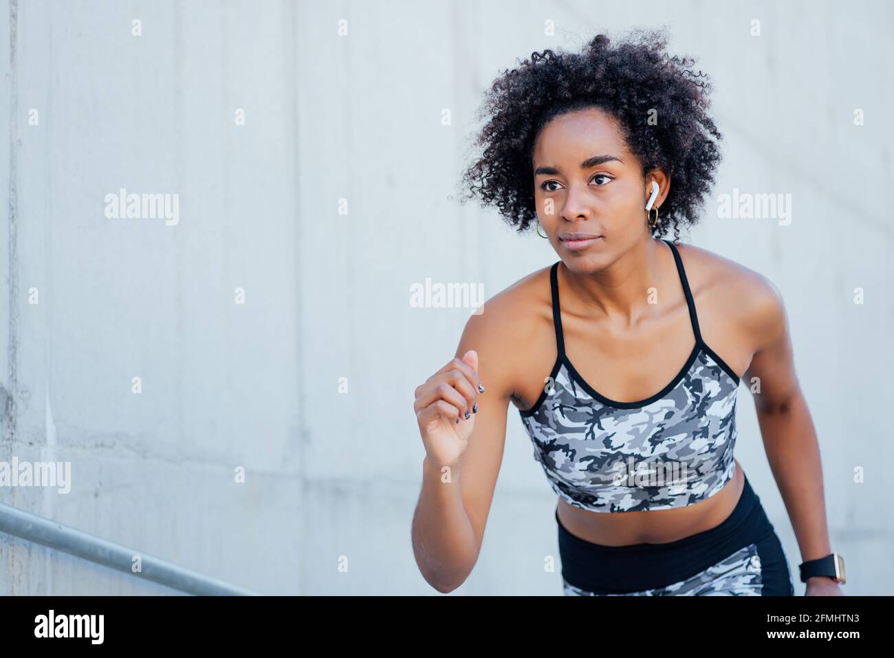 Afro athletic woman running outdoors Stock Photo - Alamy