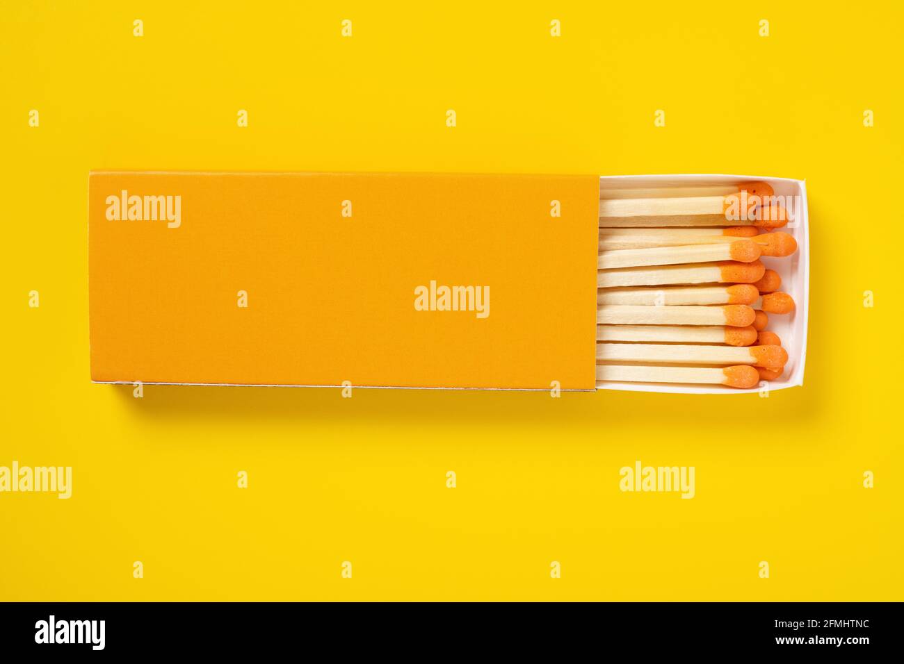 orange color matchbox and orange match sticks on a orange background ...