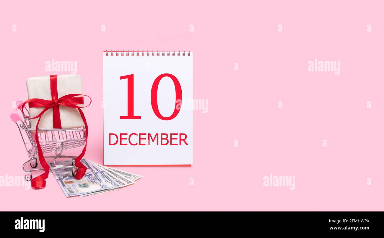 10th day of december. A gift box in a shopping trolley, dollars and a ...
