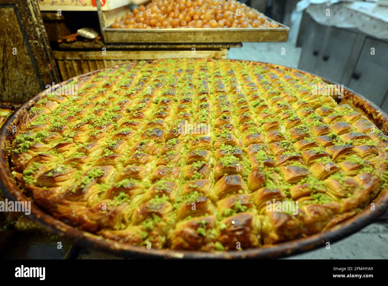 Traditional Arabic Baklava pastries sold at a small pastry shop in the ...