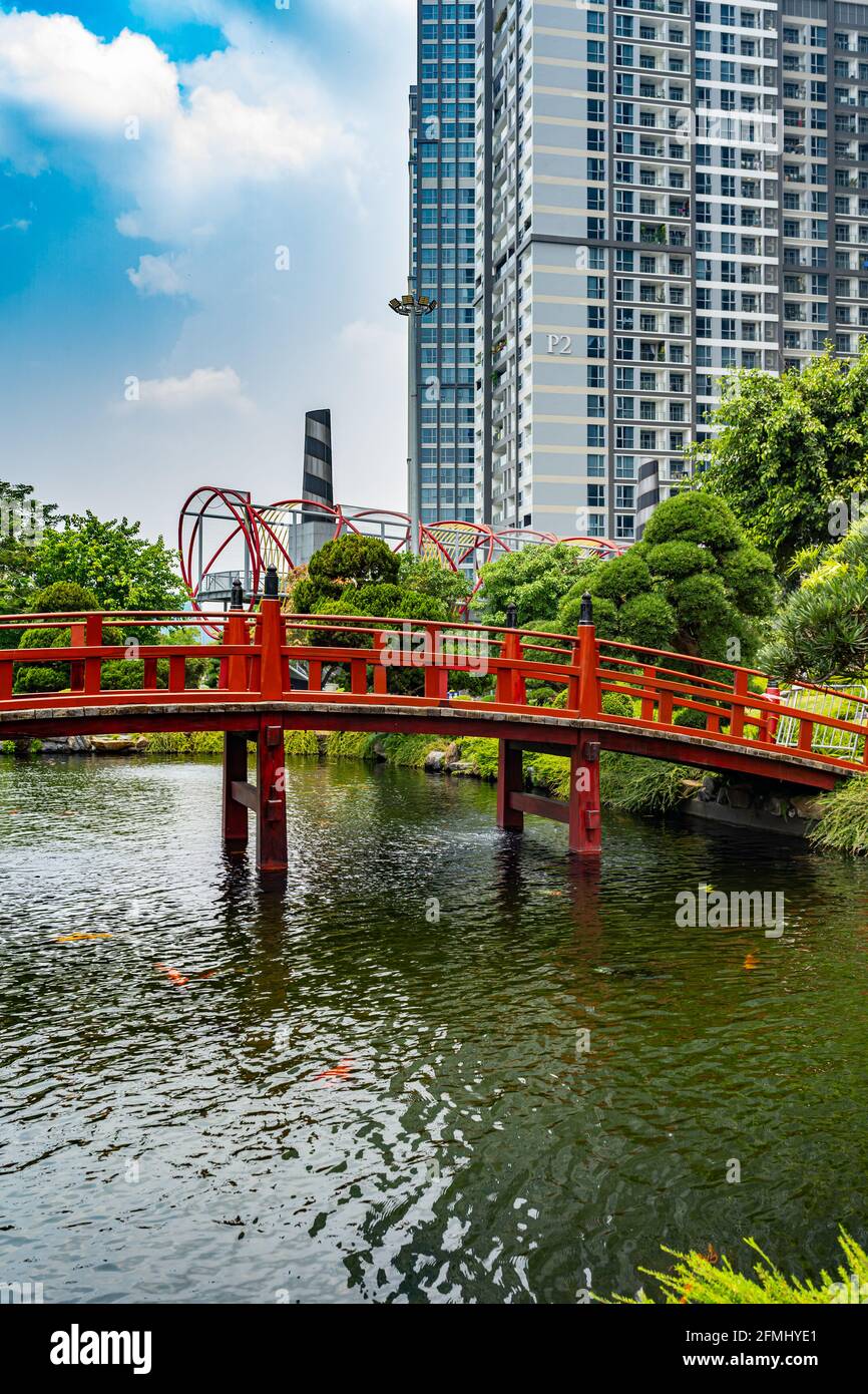Red wooden bridge in Japanese garden at outside of residential complex ...