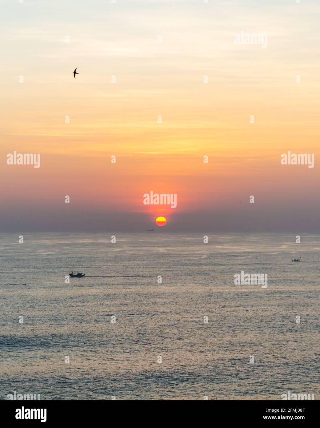 Spectacular view of calm rippling sea under colorful sundown sky and ...