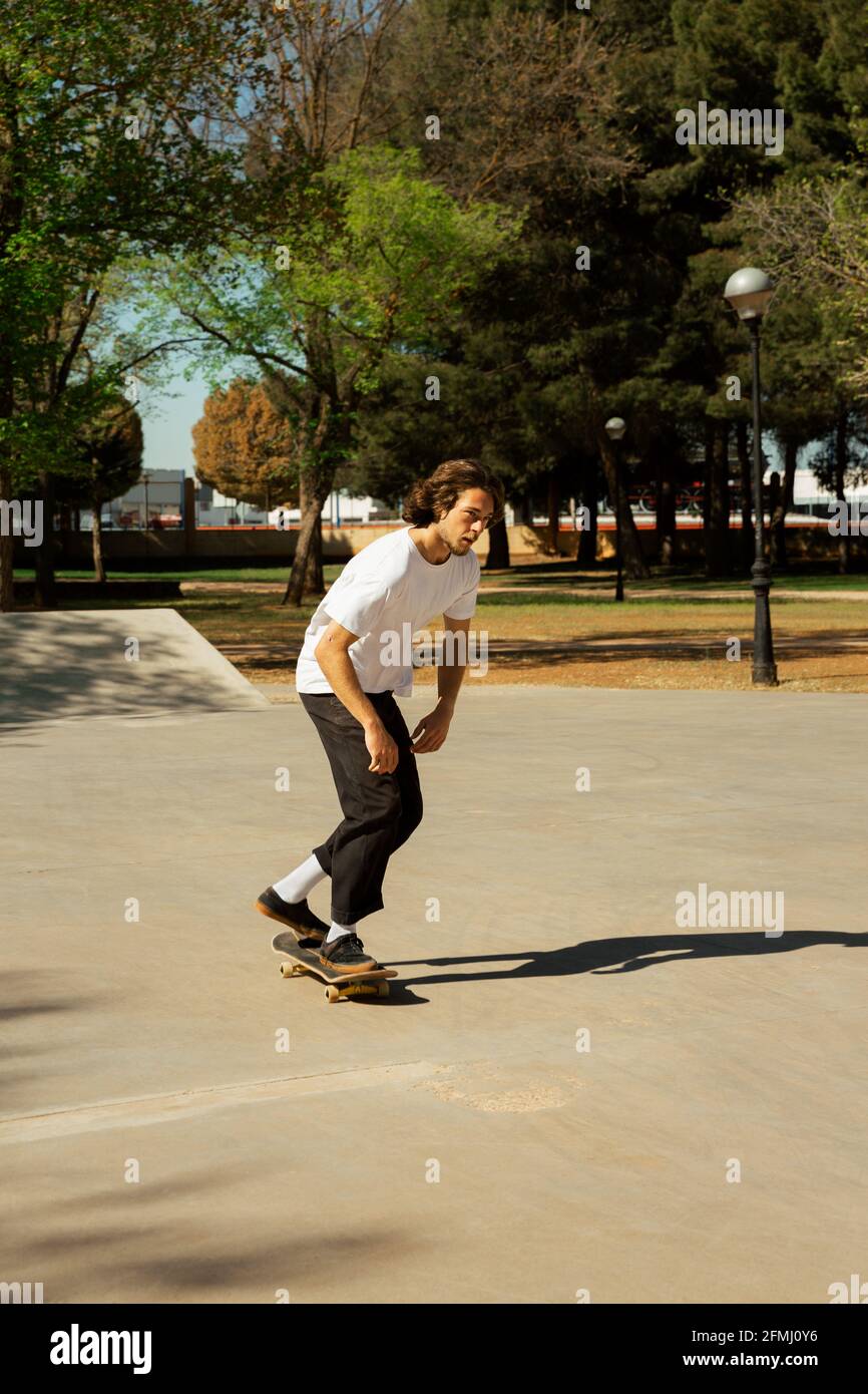 man riding skateboard in a park Stock Photo - Alamy