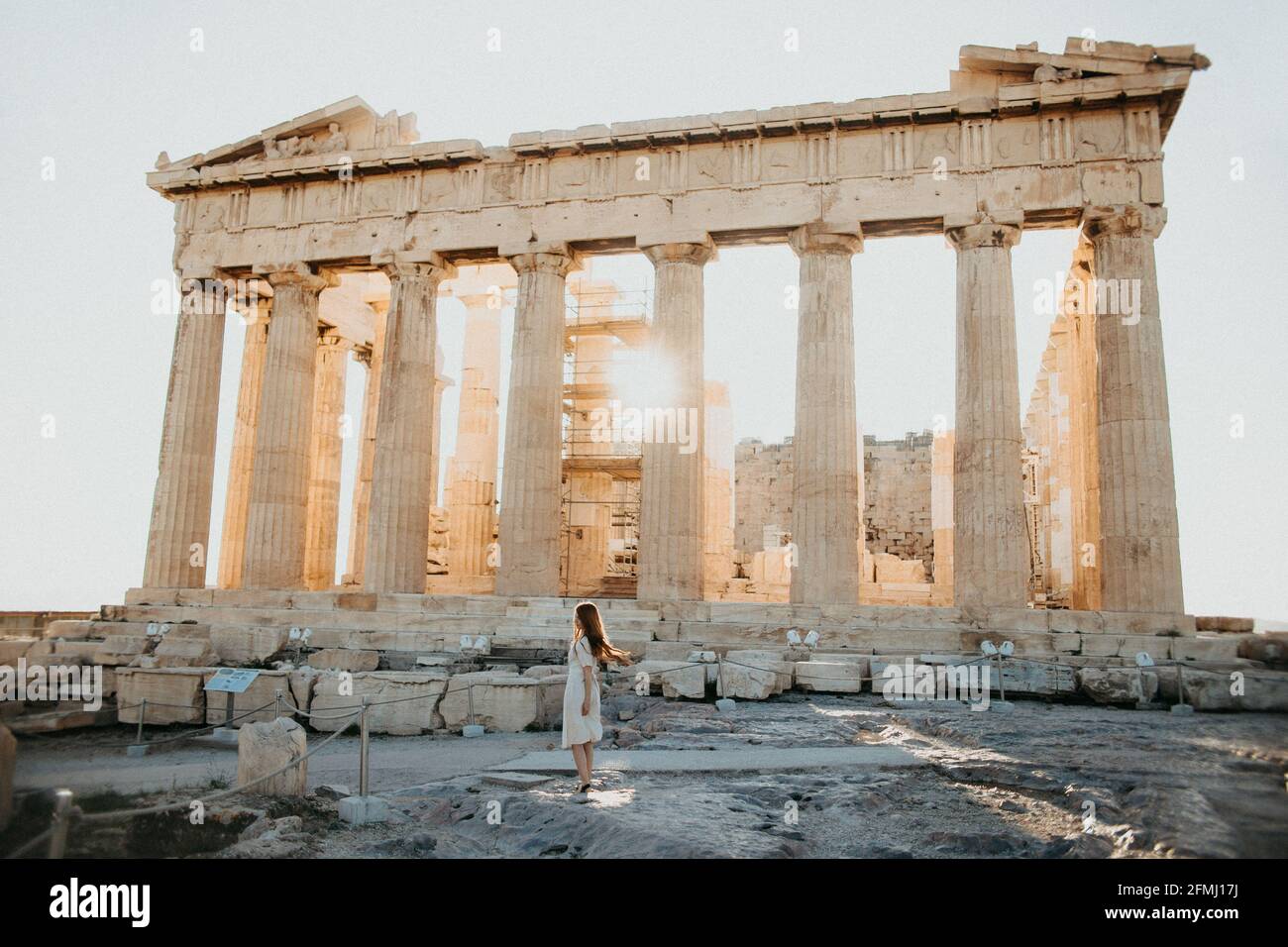 Side view of anonymous female tourist against partially destroyed aged ...