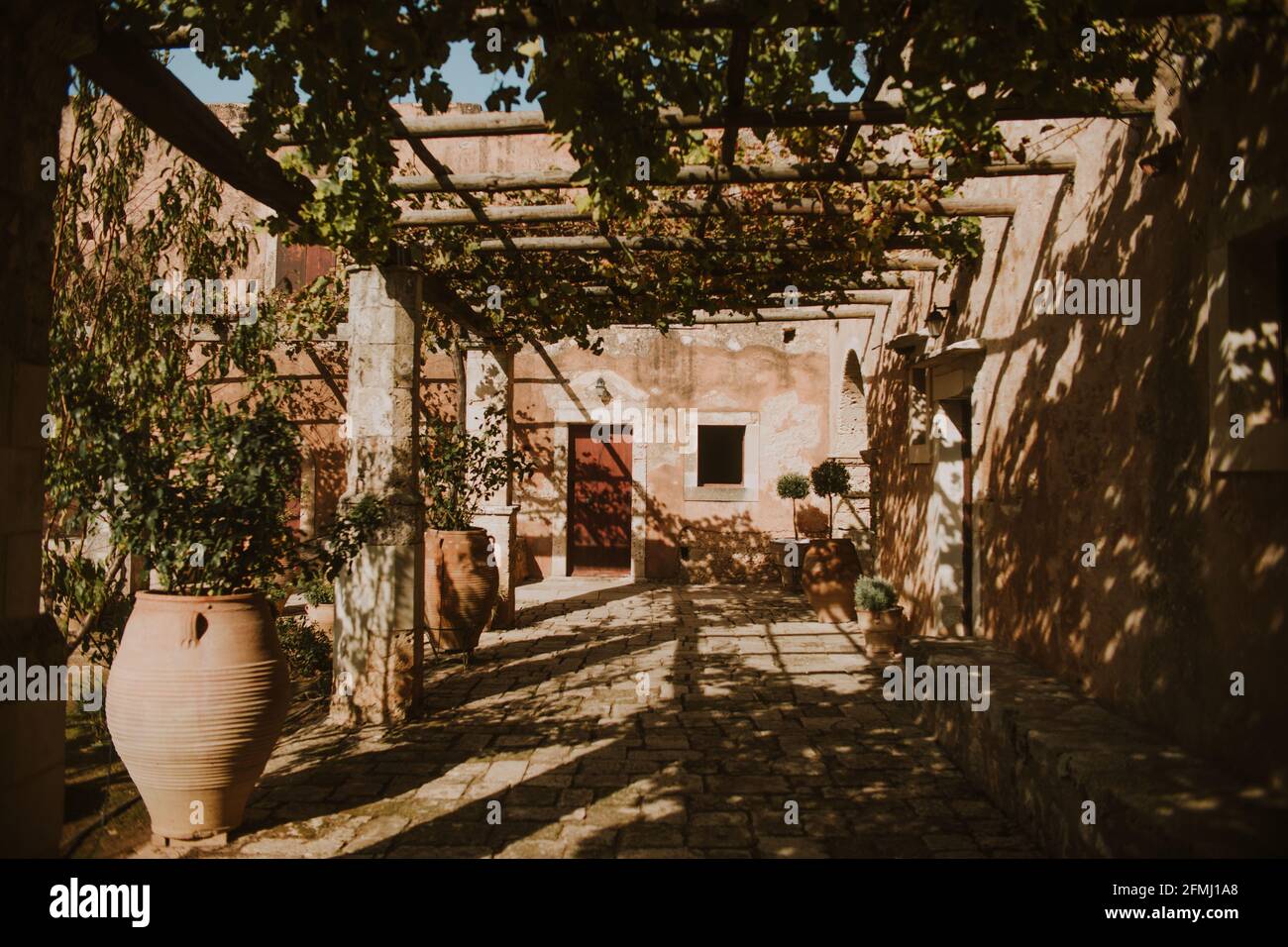 Medieval Arkadi Monastery patio with weathered shabby walls and ...