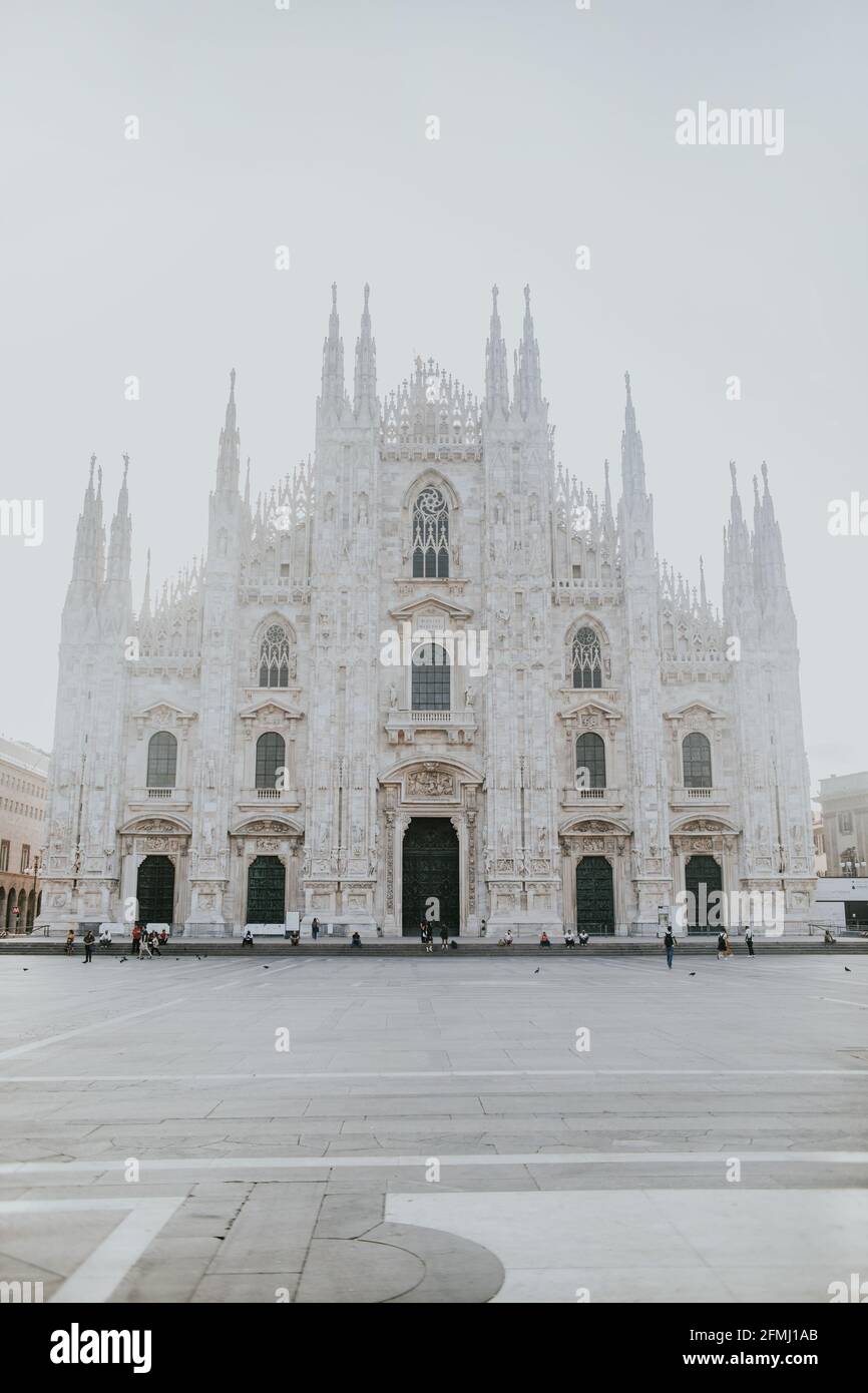 Old masonry church exterior with ornament between buildings under shiny ...