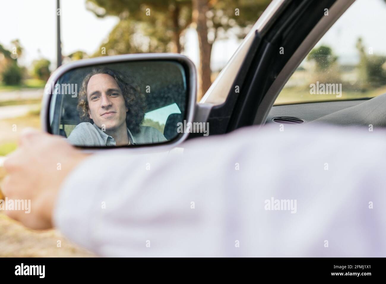 Man looking rear view mirror in car hi-res stock photography and images ...