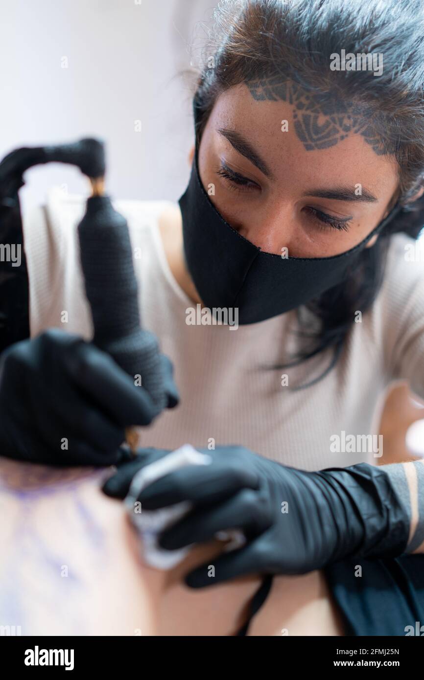 Female tattooer in cloth face hi-res stock photography and images - Alamy