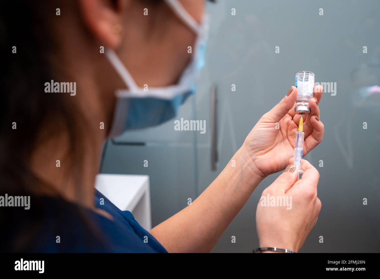 Side view of cropped unrecognizable female veterinarian in cloth face ...