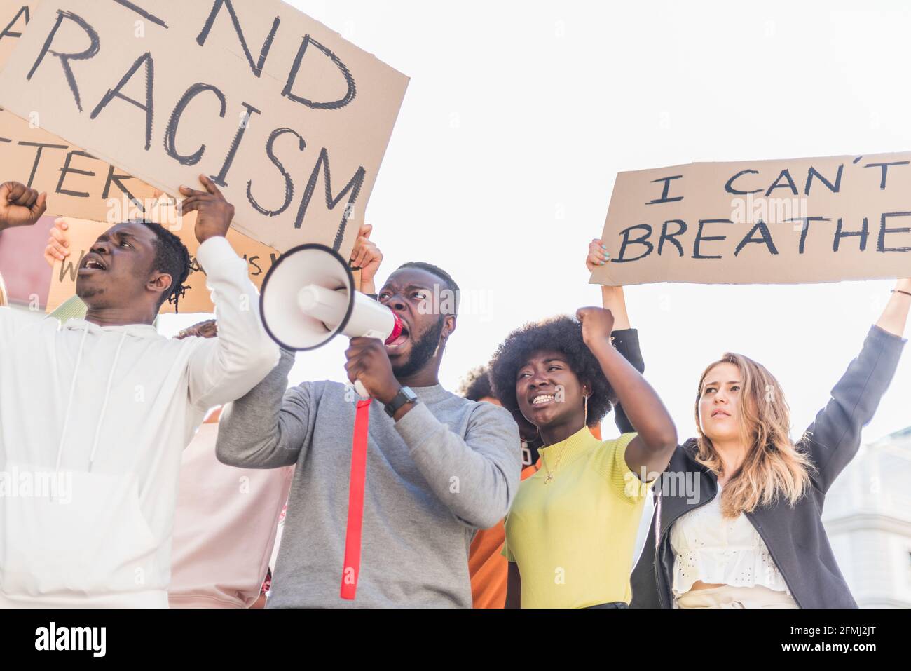 African American male screaming in megaphone during Black Lives Matter ...
