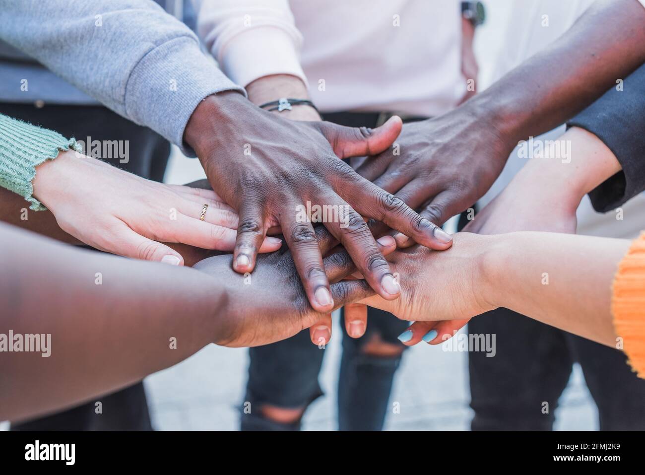 Crop unrecognizable multiethnic social justice warriors joining hands ...