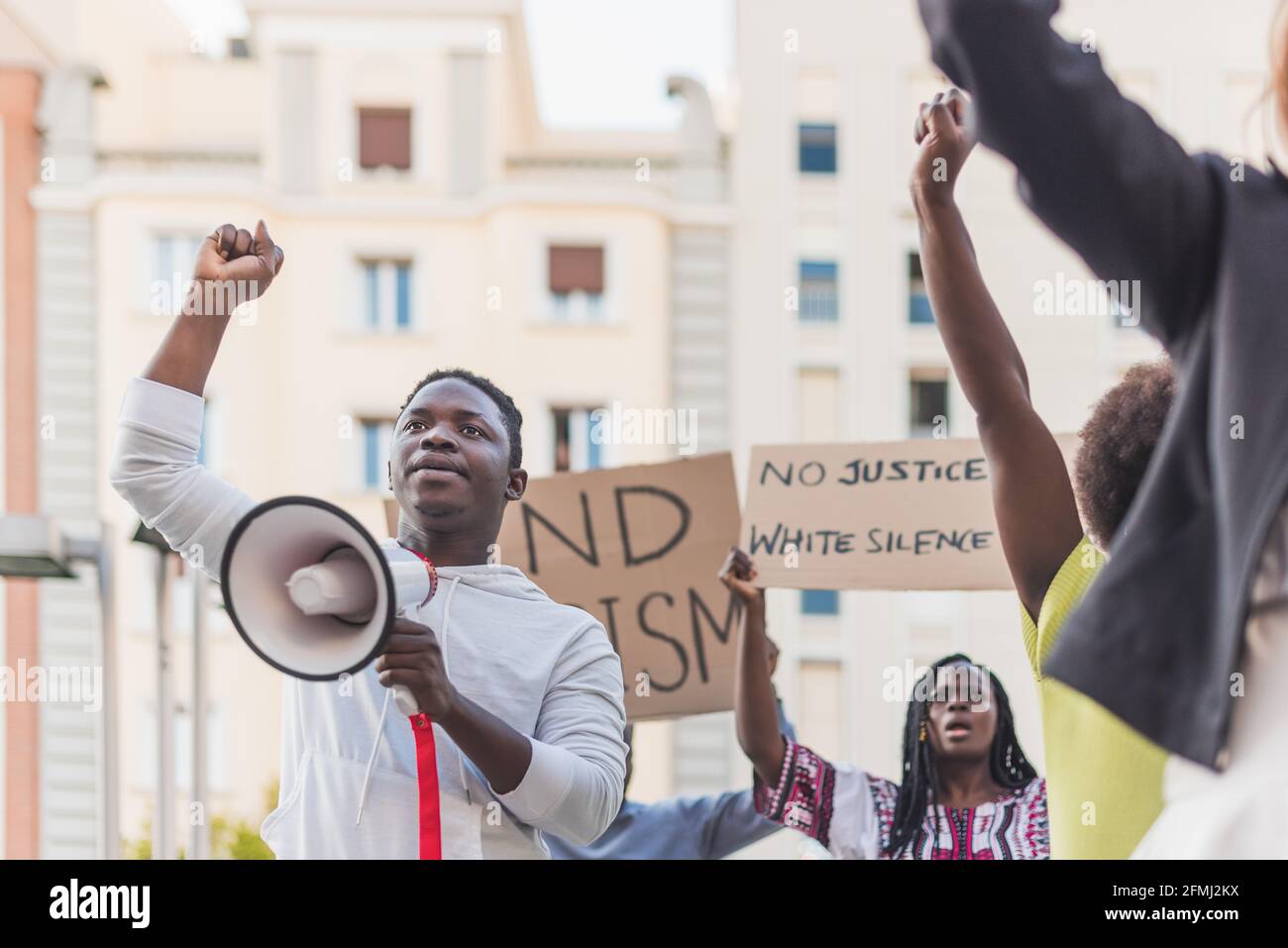 African American male screaming in megaphone during Black Lives Matter ...