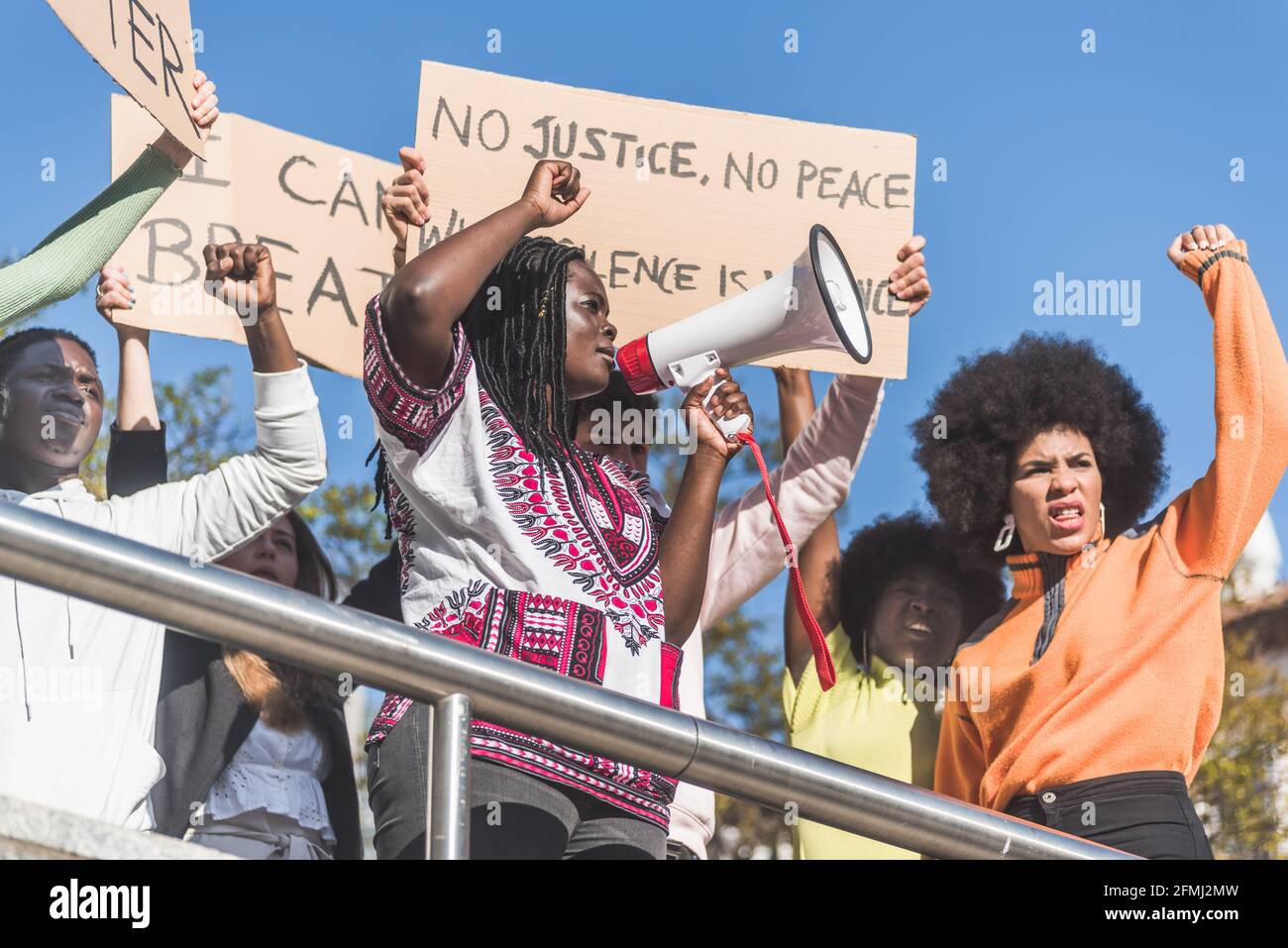 From below of crowd of multiracial protesters with placards and ...