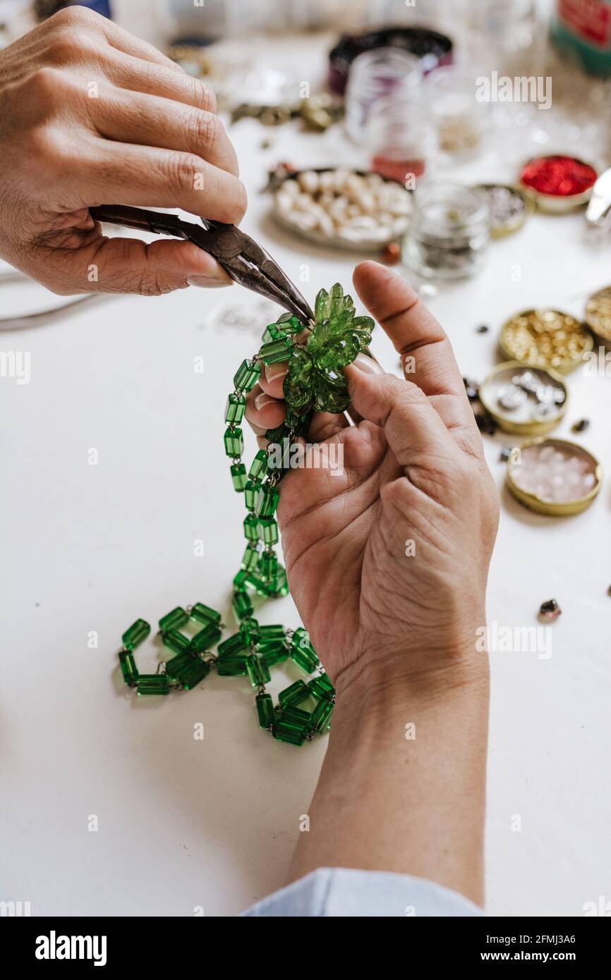 High angle of crop anonymous female master with instrument making ...