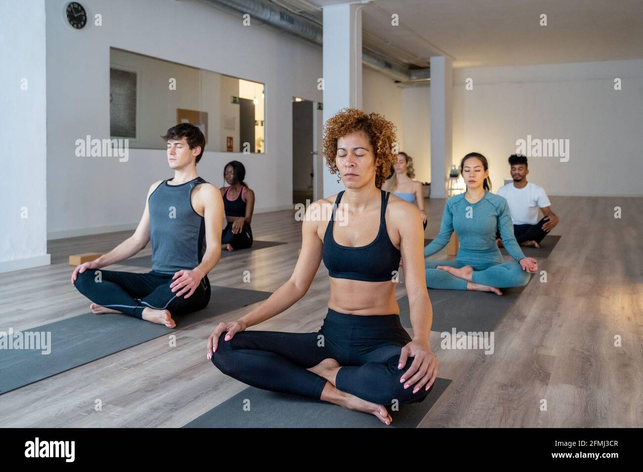 African American Woman with group of diverse people sitting in Lotus ...