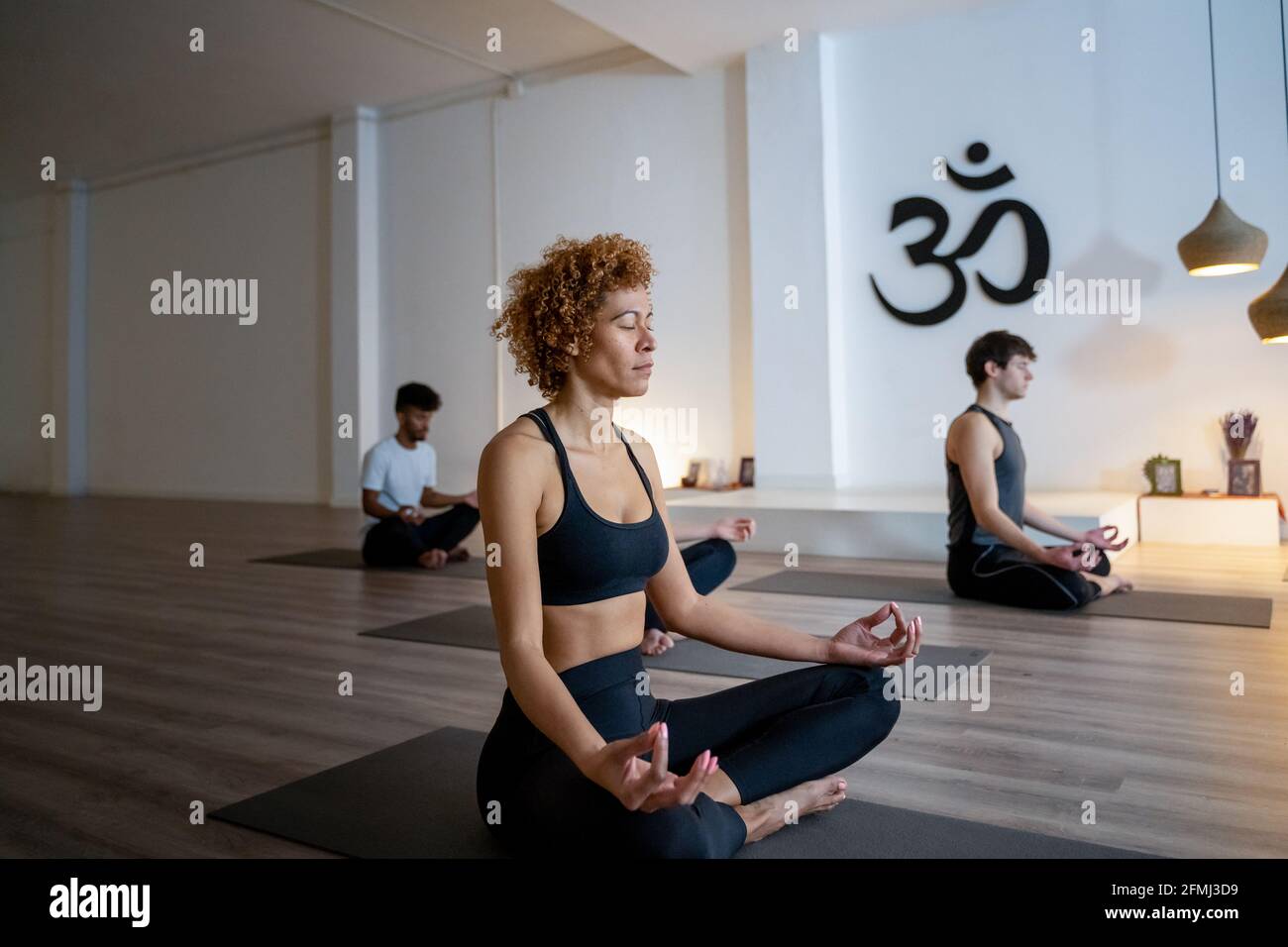 African American Woman with group of diverse people sitting in Lotus ...