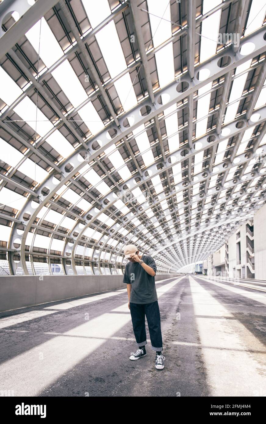 Full body faceless male standing in creative pedestrian tunnel with ...